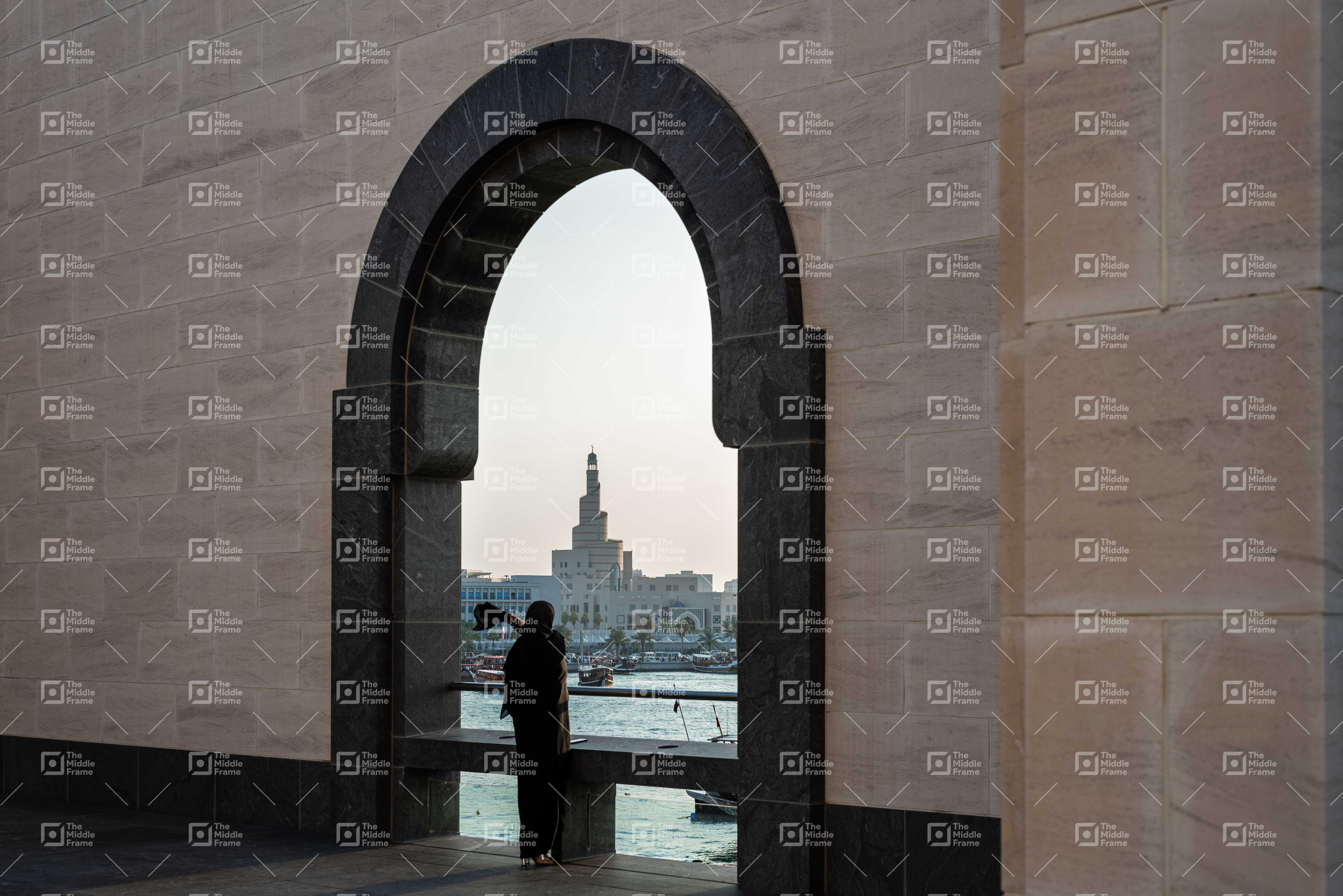 Woman standing in traditional Qatari clothes abaya • The Middle Frame ...